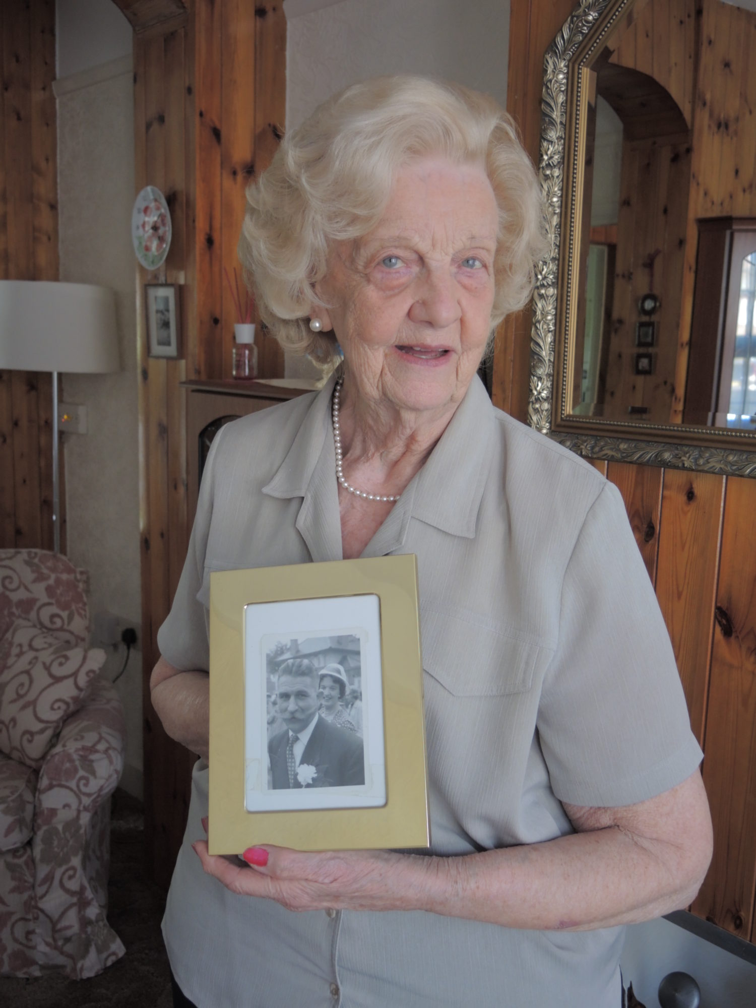 Audrey Bird holding a photo of Gerald Bird. - Frank Falla Archive
